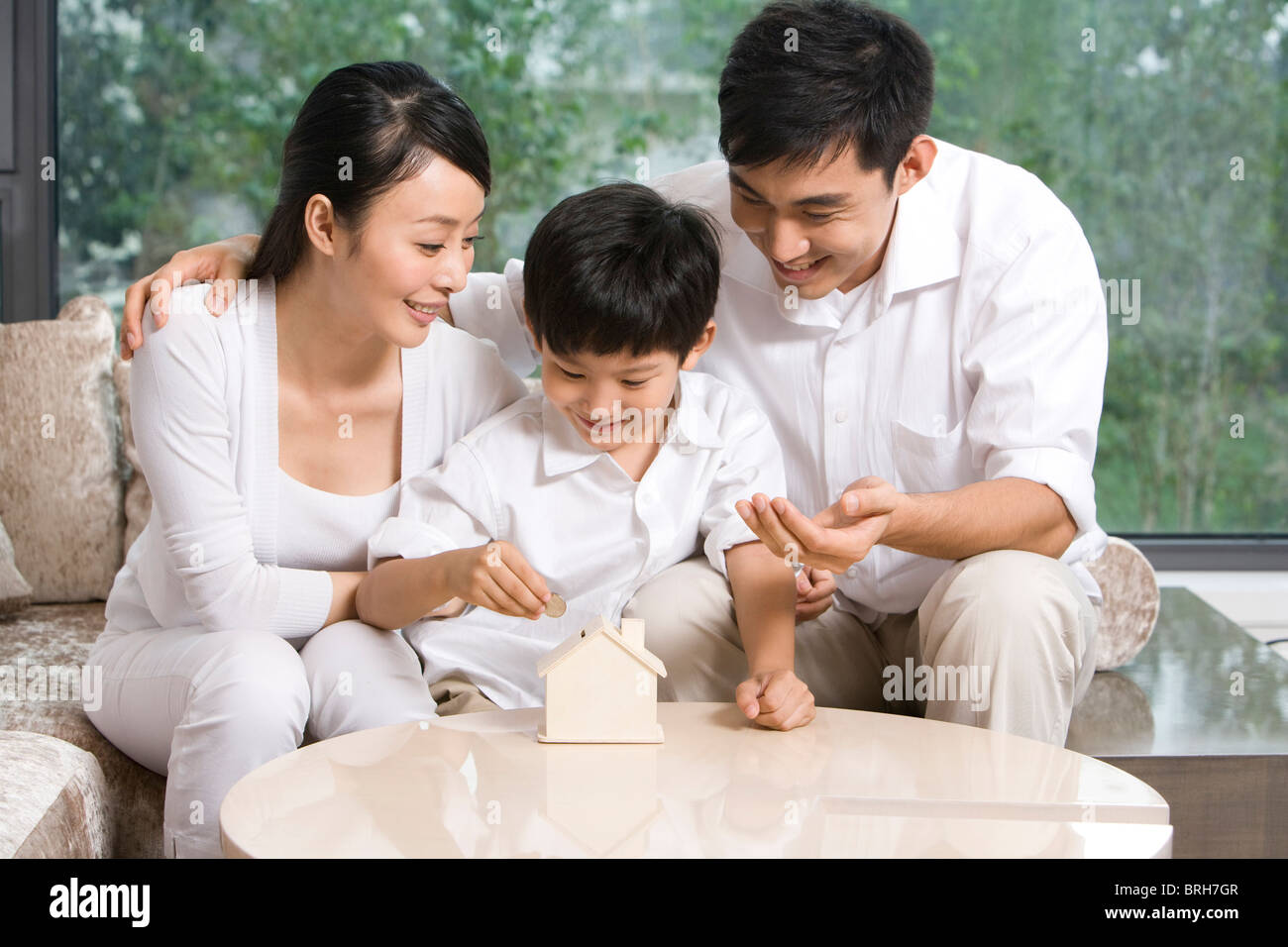 Family saving for new home Stock Photo - Alamy