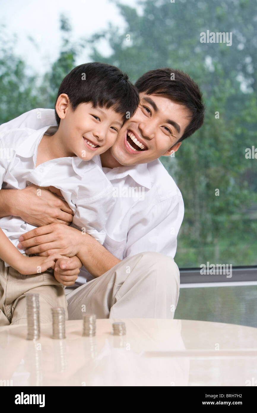 Father and son calculating coins Stock Photo - Alamy