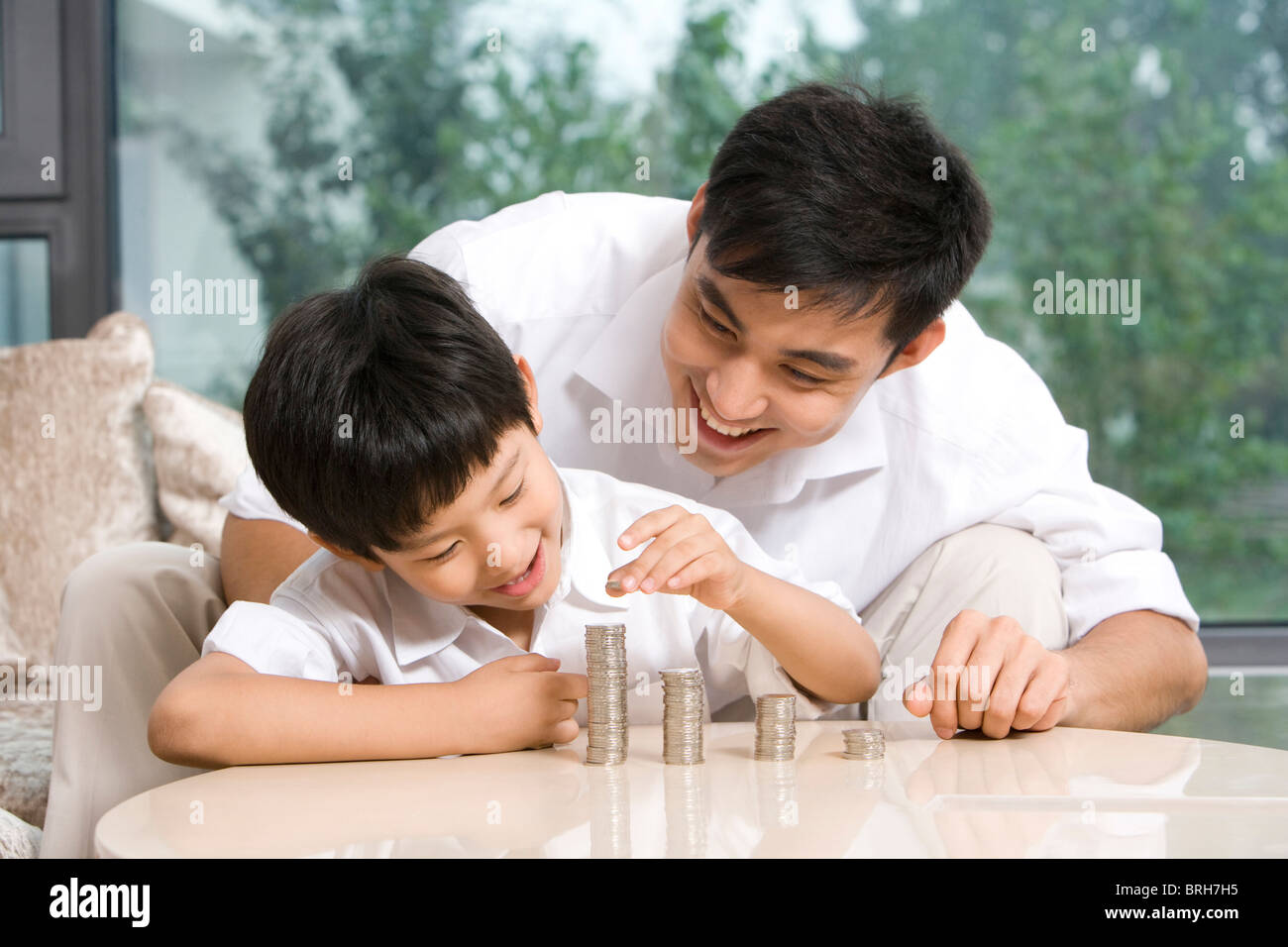 Father and son counting money hi-res stock photography and images - Alamy