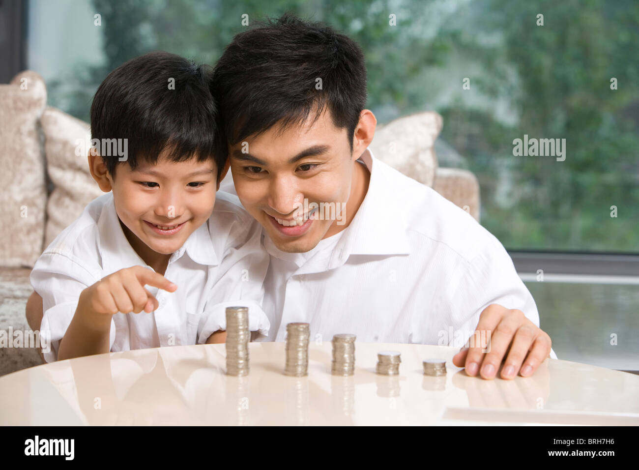 Father and son counting money hi-res stock photography and images - Alamy