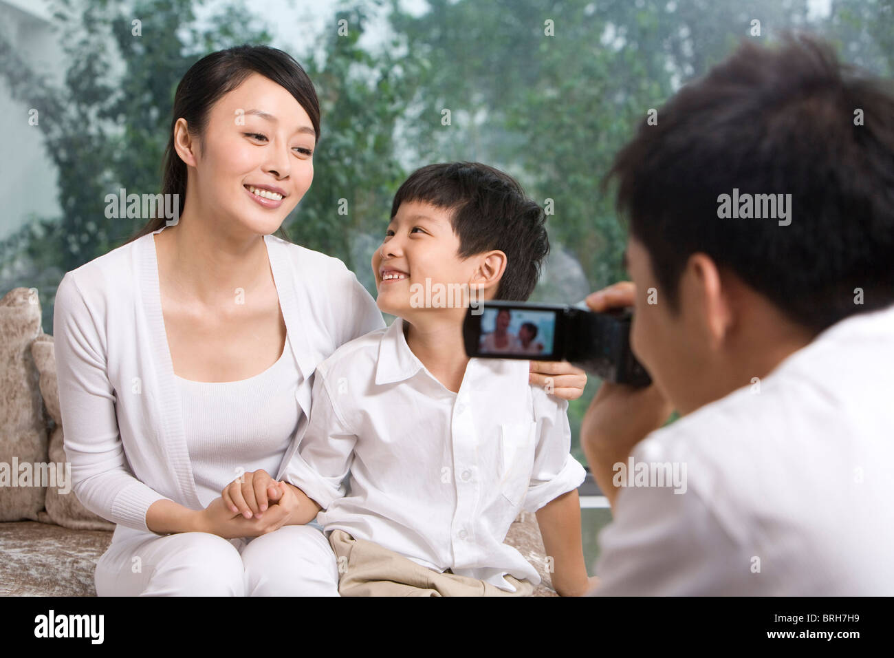 Father taking pictures for family Stock Photo - Alamy