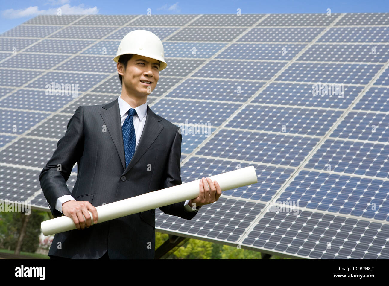 Portrait of an engineer in front of solar panels Stock Photo - Alamy
