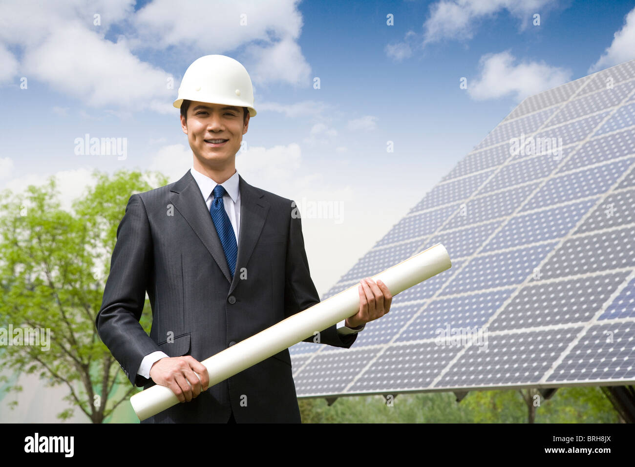 Portrait of an engineer in front of solar panels Stock Photo - Alamy