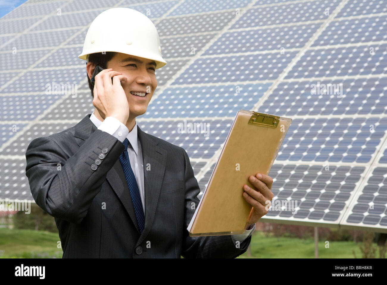 Portrait of an engineer in front of solar panels Stock Photo - Alamy