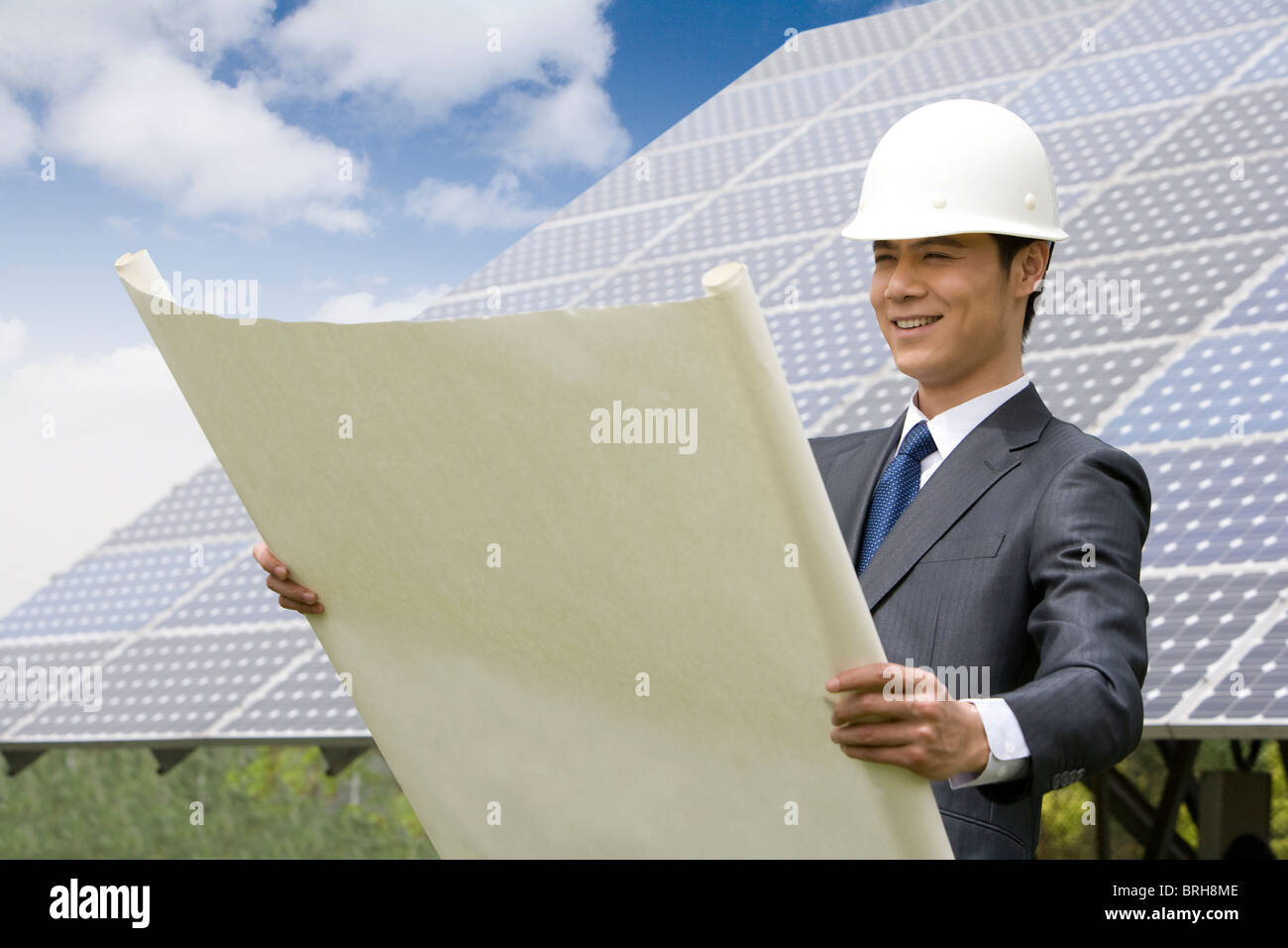 Portrait of an engineer in front of solar panels Stock Photo - Alamy