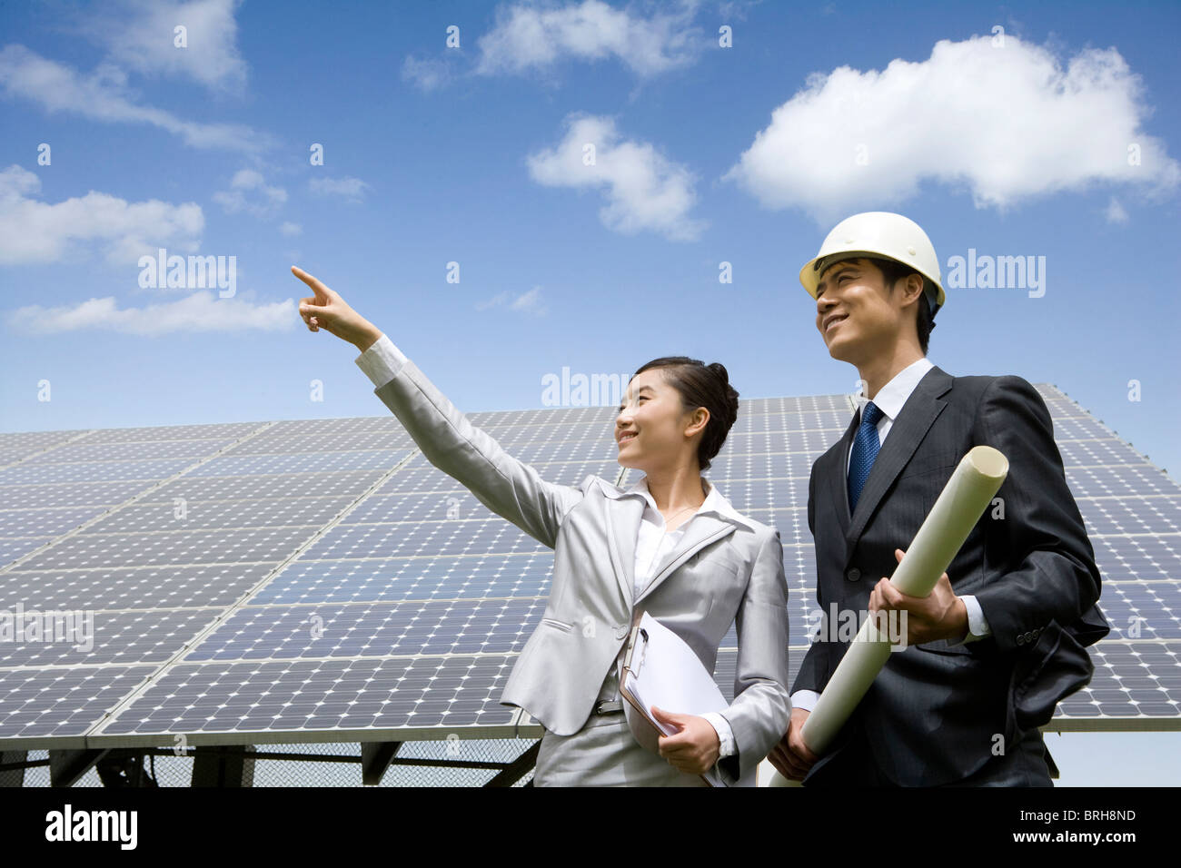 Two engineers in front of solar panels Stock Photo - Alamy