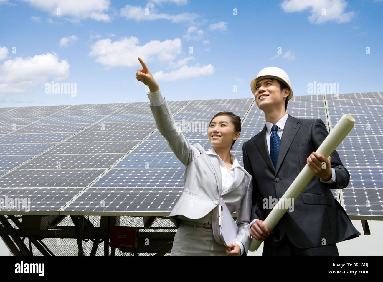 Two engineers in front of solar panels Stock Photo - Alamy