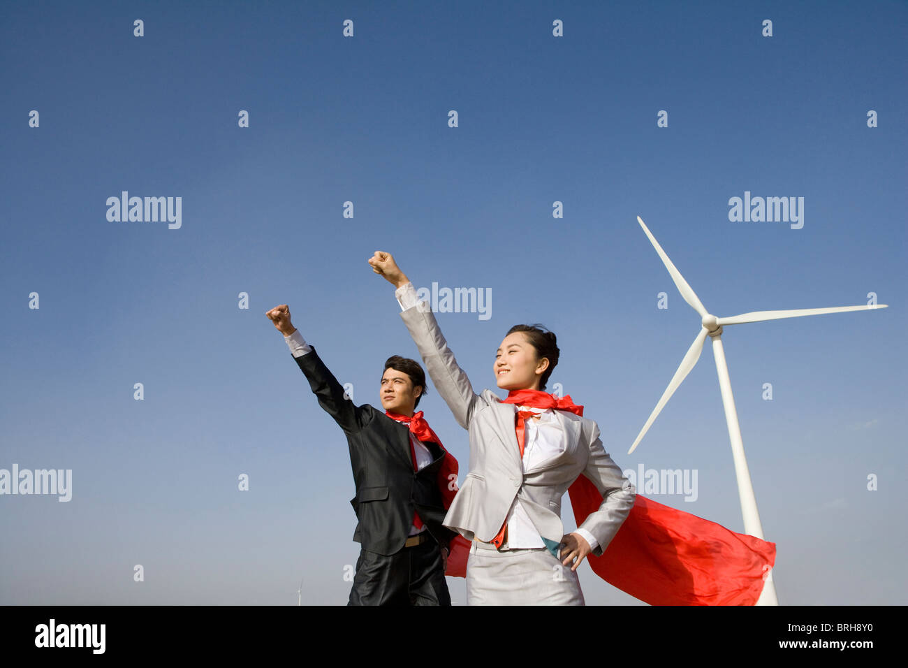 Everyday heroes in front of wind turbines Stock Photo - Alamy