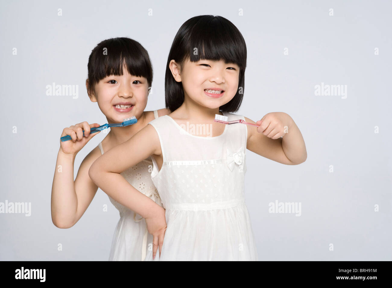 Little girls brushing teeth Stock Photo - Alamy
