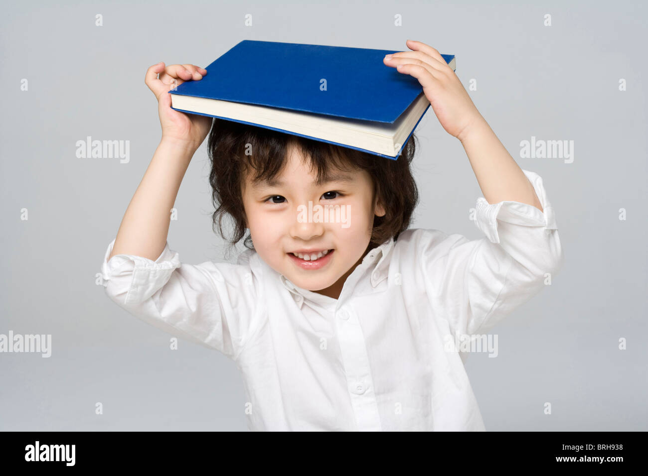 Little boy holding a book Stock Photo - Alamy
