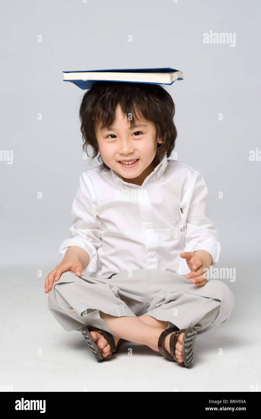 Children balancing book on head hi-res stock photography and images - Alamy