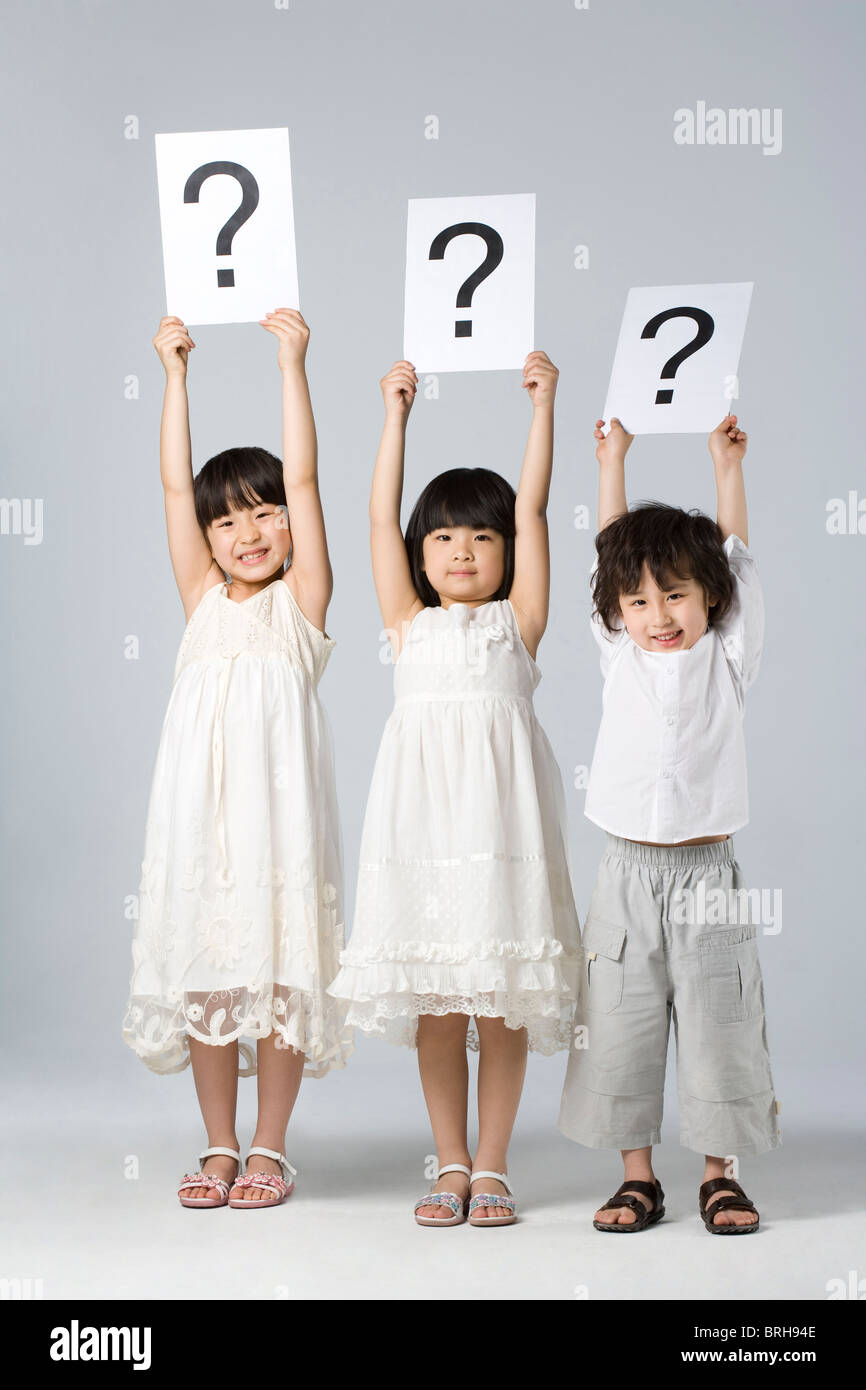 Children holding signs with question marks Stock Photo - Alamy