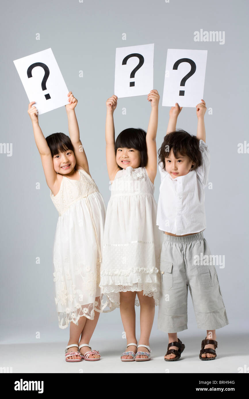 Children holding signs with question marks Stock Photo - Alamy