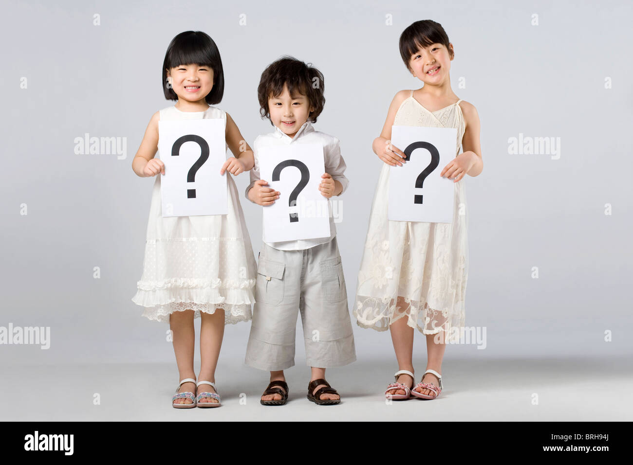 Children holding signs with question marks Stock Photo - Alamy