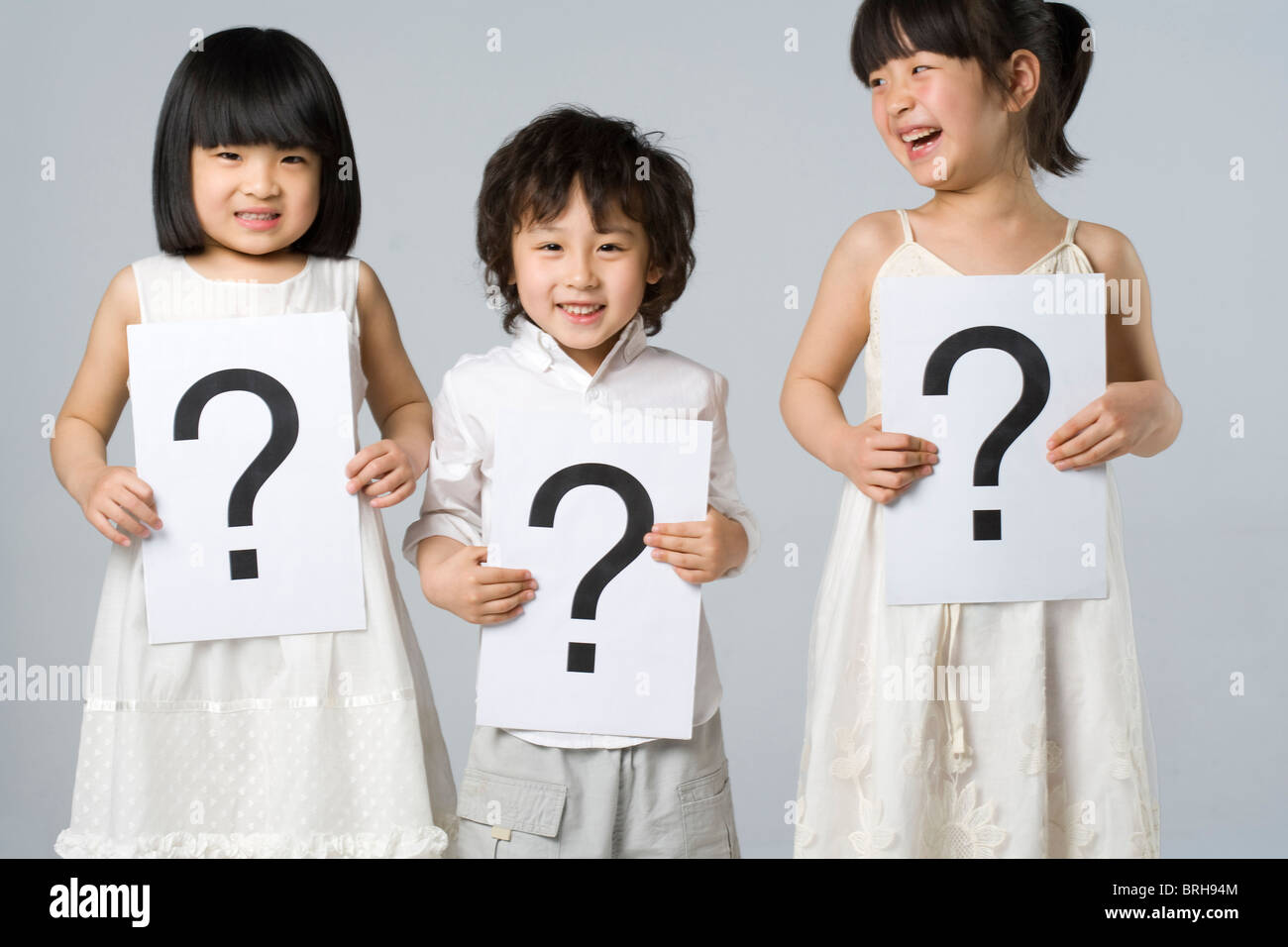 Children holding signs with question marks Stock Photo - Alamy