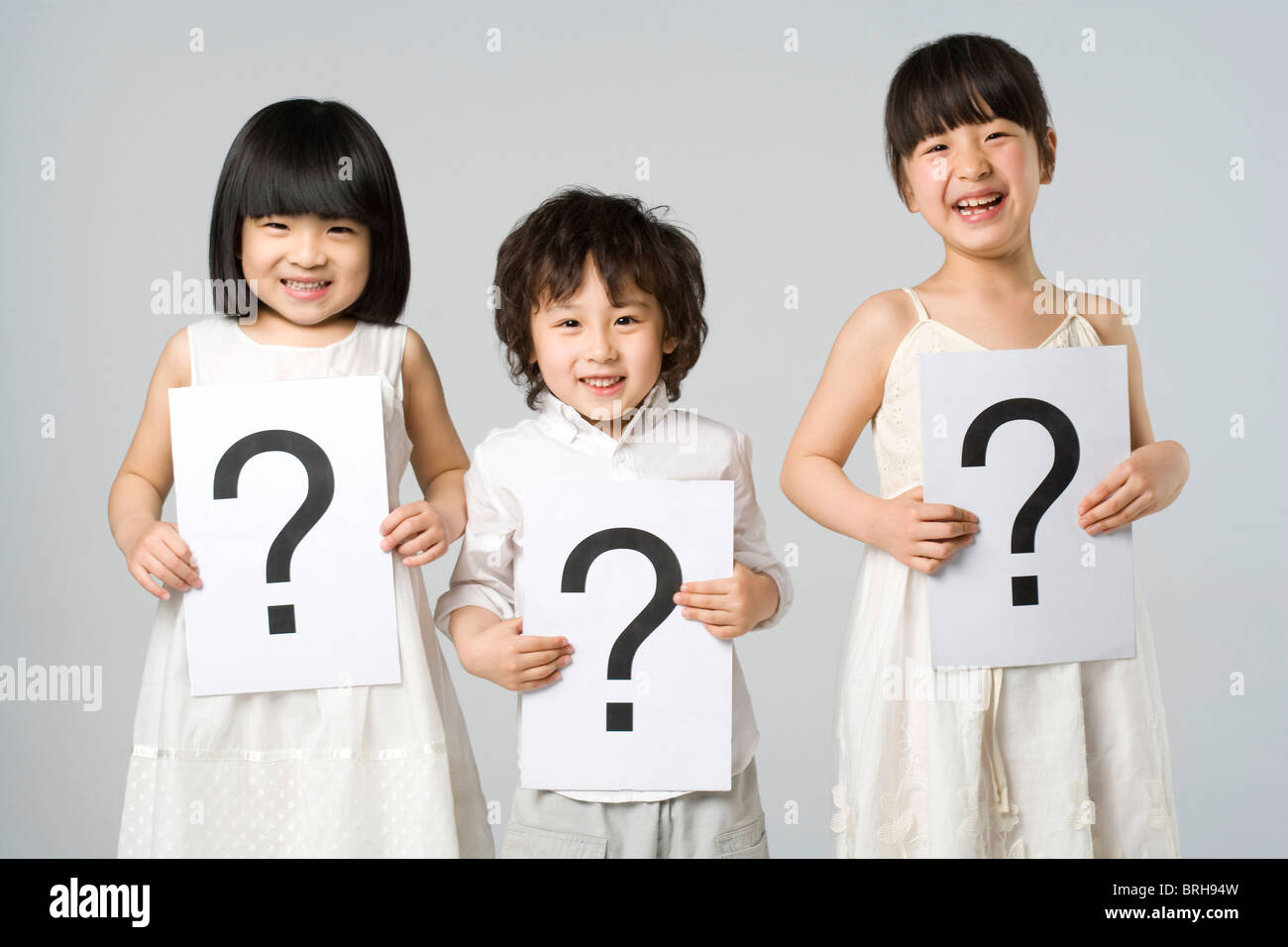 Children holding signs with question marks Stock Photo - Alamy