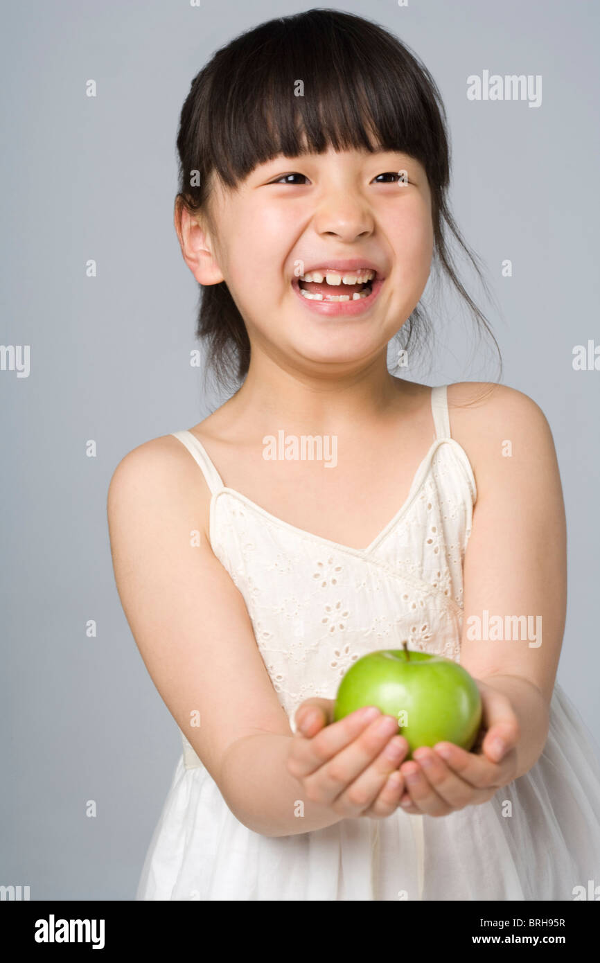 Girl holding an apple Stock Photo - Alamy