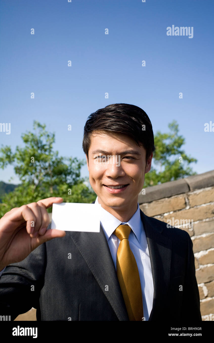Businessman holding a name card on the Great Wall Stock Photo - Alamy