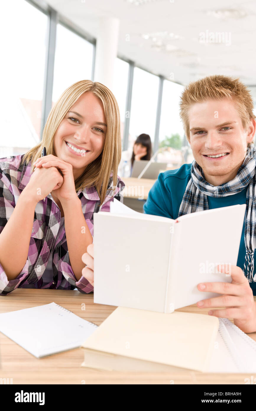 Back to school - happy students with books in classroom Stock Photo - Alamy