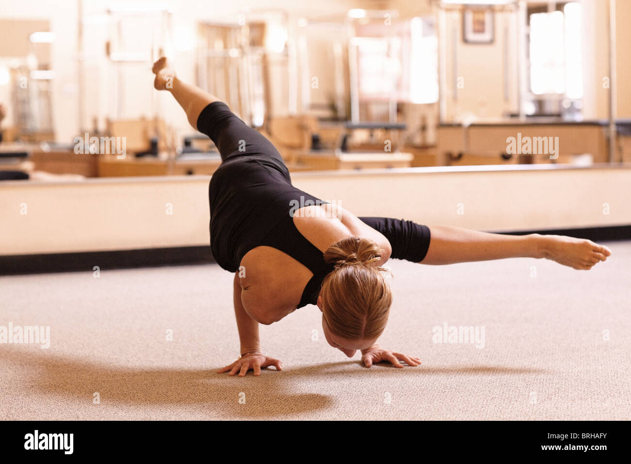 Woman Demonstrating Balance and Strength Pose in Pilates Class Stock ...