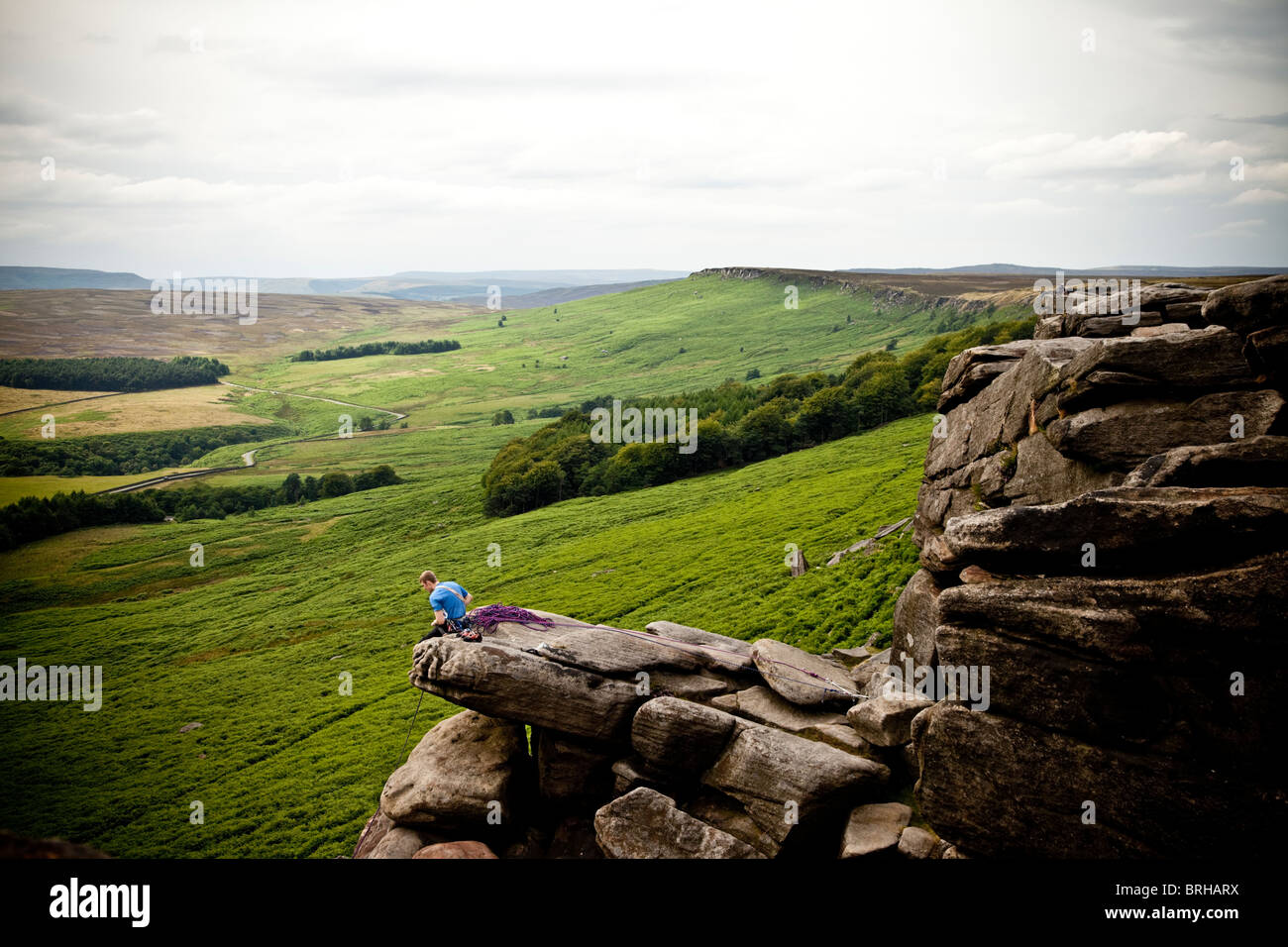 Rock climbers in action in the Peak District Park of Stanage Edge in ...