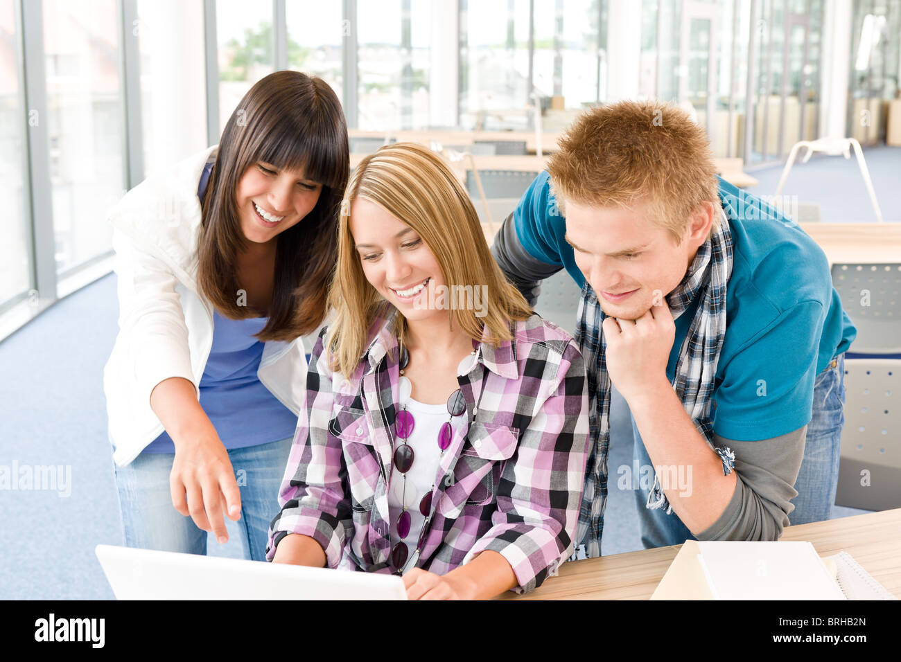 Students with books and laptop in classroom at high school Stock Photo ...