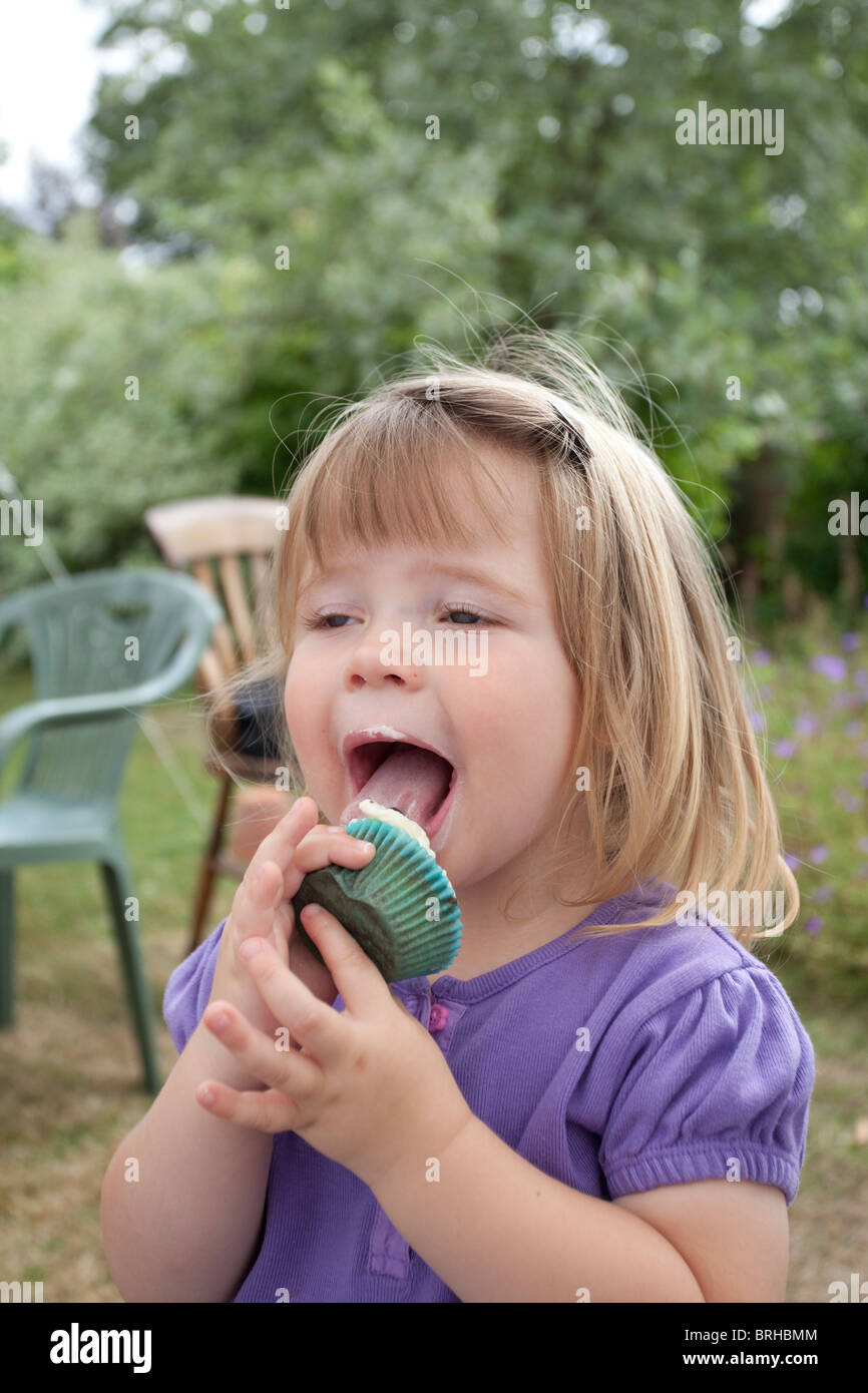 Girl licking cake icing hi-res stock photography and images - Alamy