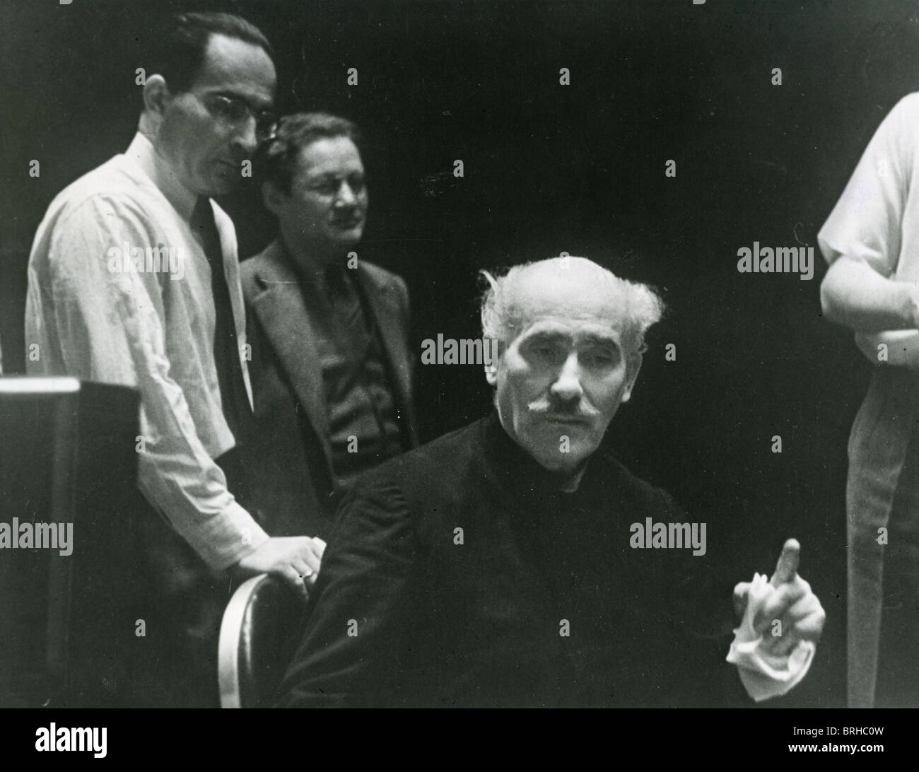 ARTURO TOSCANINI, Italian conductor, listening to the playback of a ...
