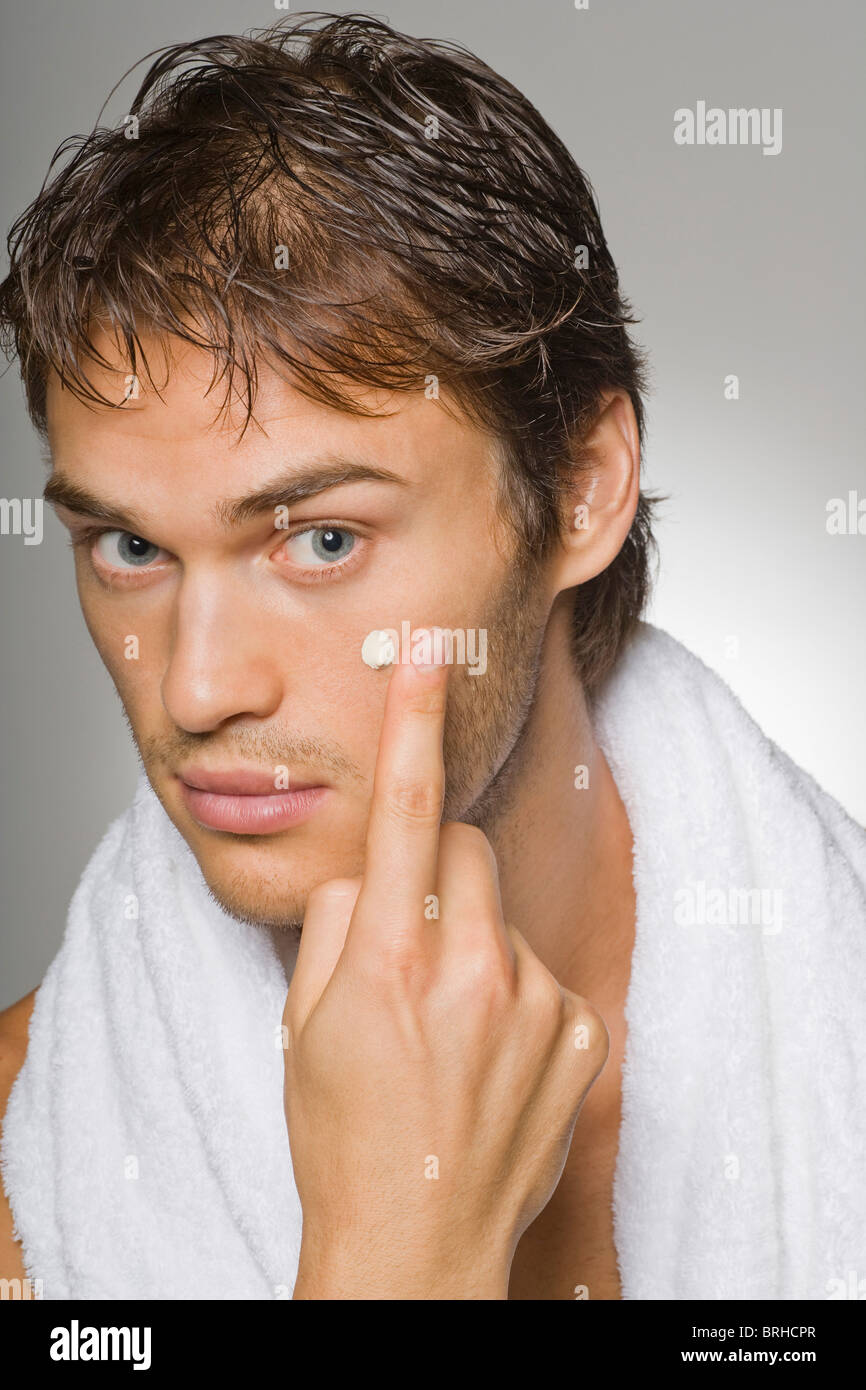 Man Applying Moisturizer to his Face Stock Photo - Alamy