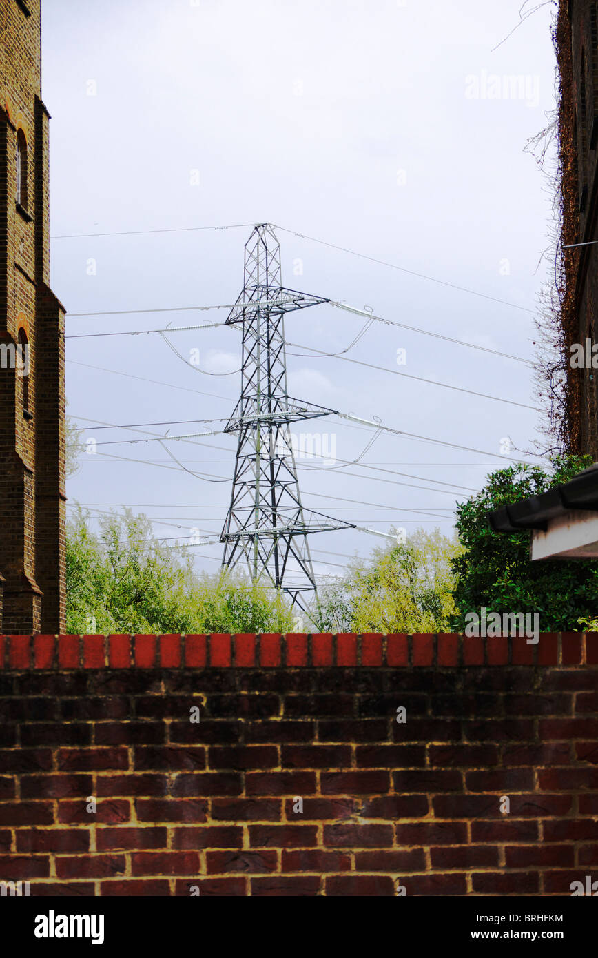 Electric pylon viewed between two buildings Stock Photo - Alamy