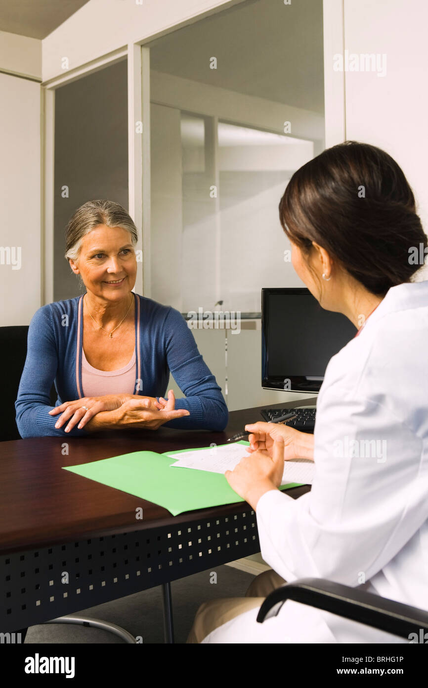 Woman Talking to Doctor Stock Photo - Alamy