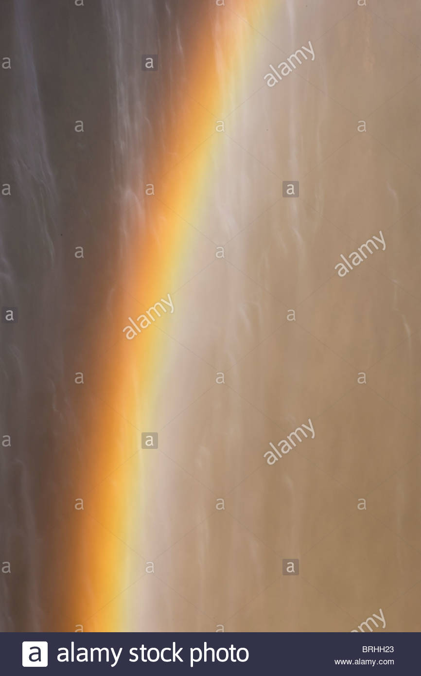 Close up of a rainbow in front of a waterfall Stock Photo - Alamy