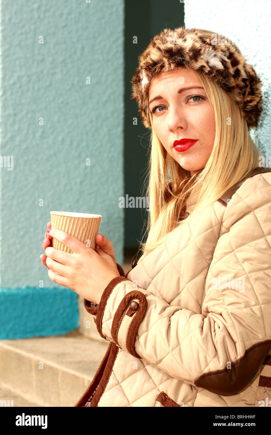 Young Woman Sitting Down Drinking Tea. Model Released Stock Photo - Alamy