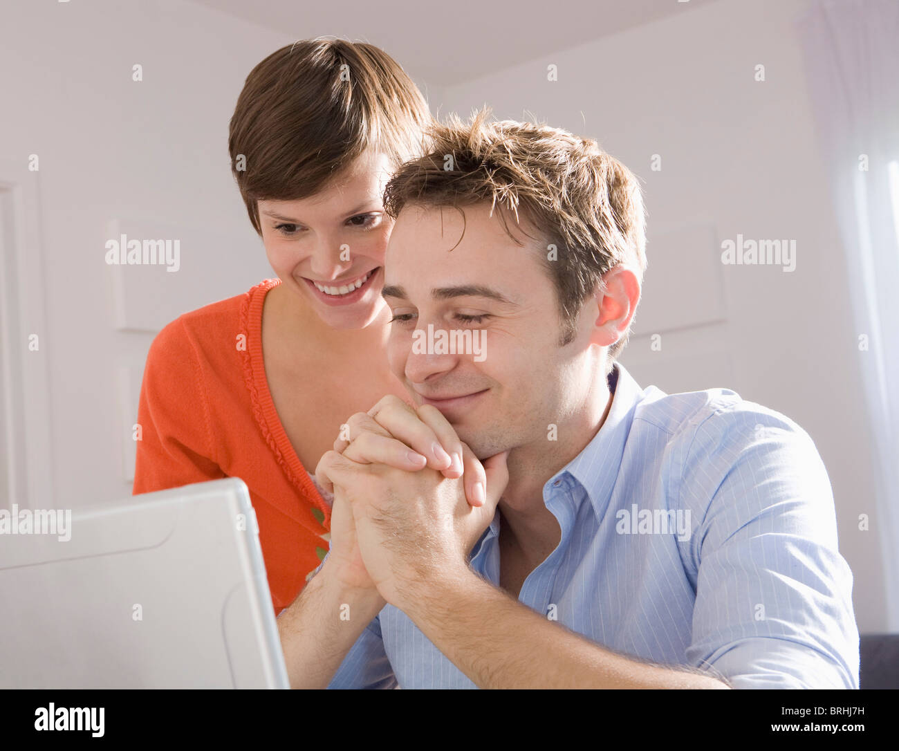 Woman with computer looking relieved hi-res stock photography and ...