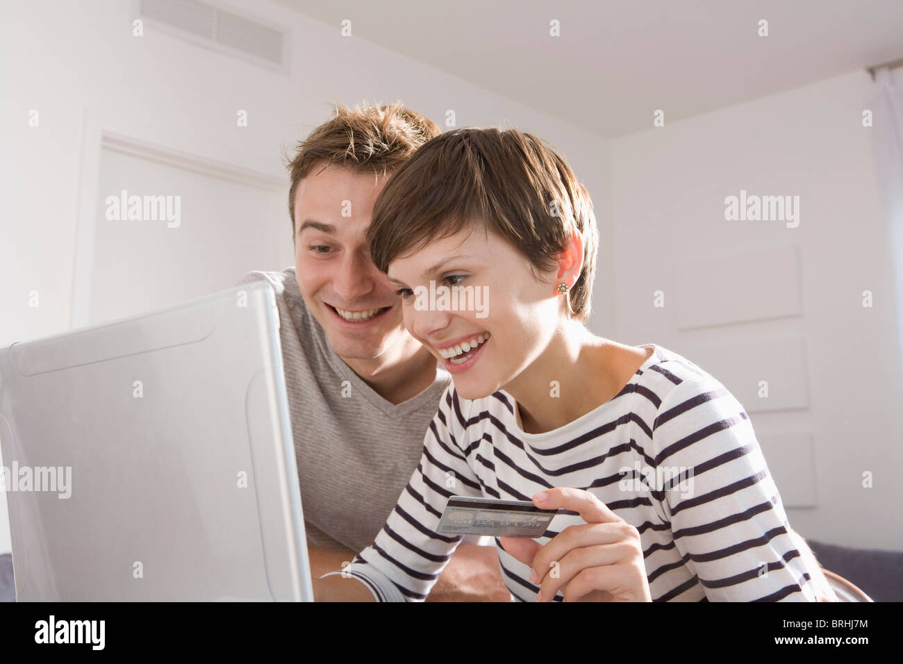 Woman with computer looking relieved hi-res stock photography and ...