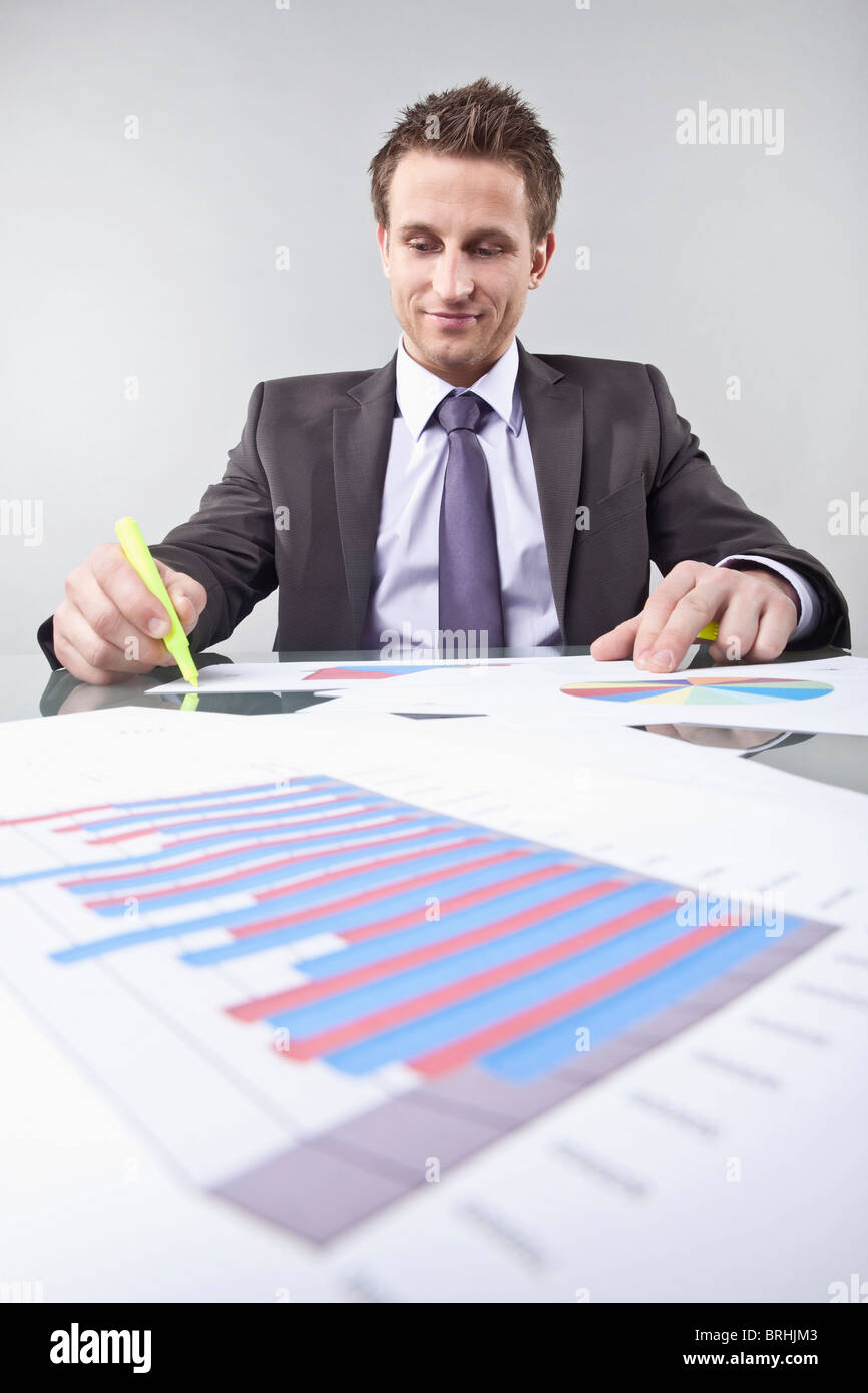 Businessman Looking at Graphs Stock Photo - Alamy