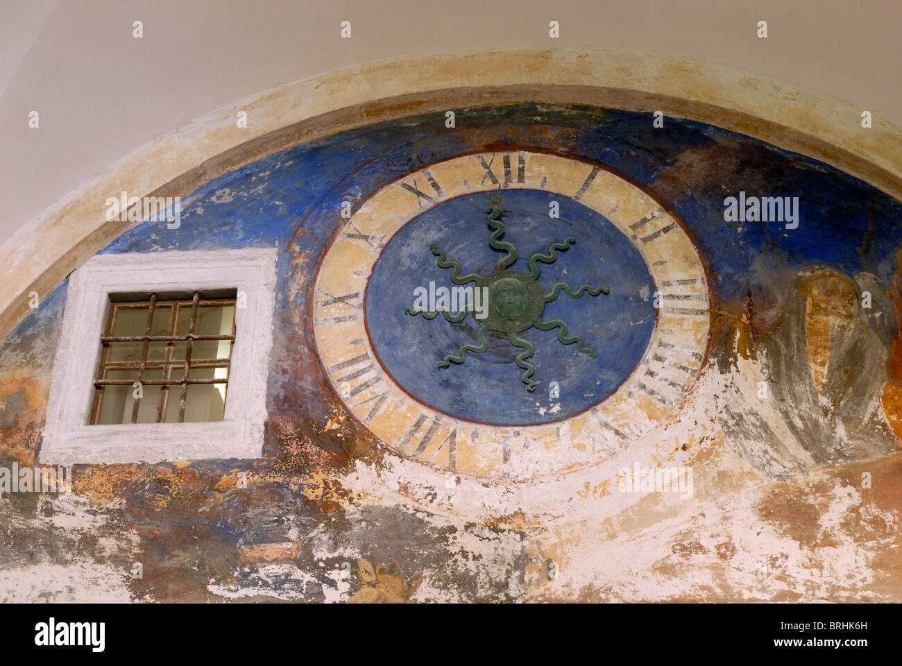 A fine view to the ancient clock and the worn frescoes on the atrium ...