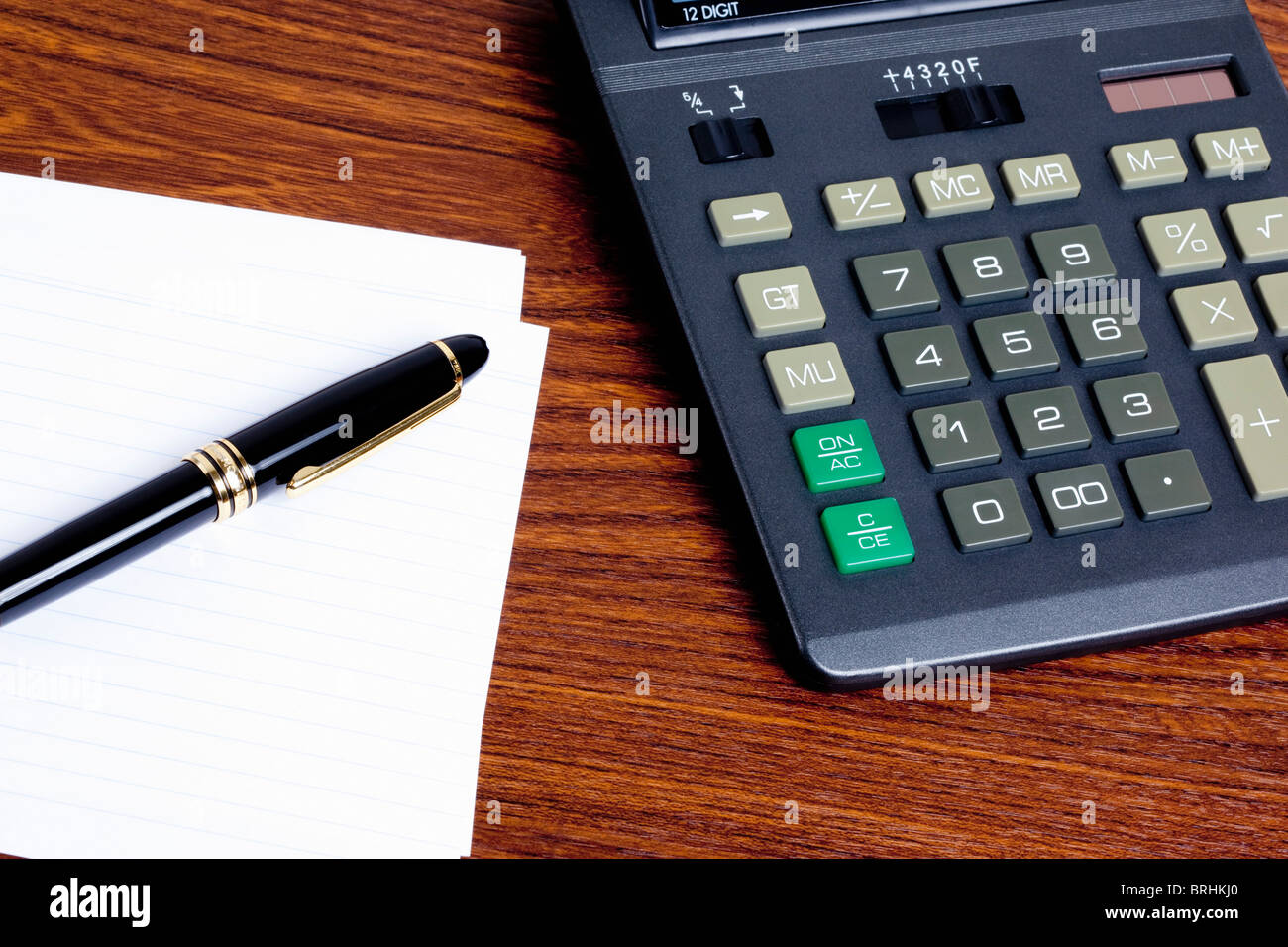 Calculator With Pen and Paper Stock Photo - Alamy