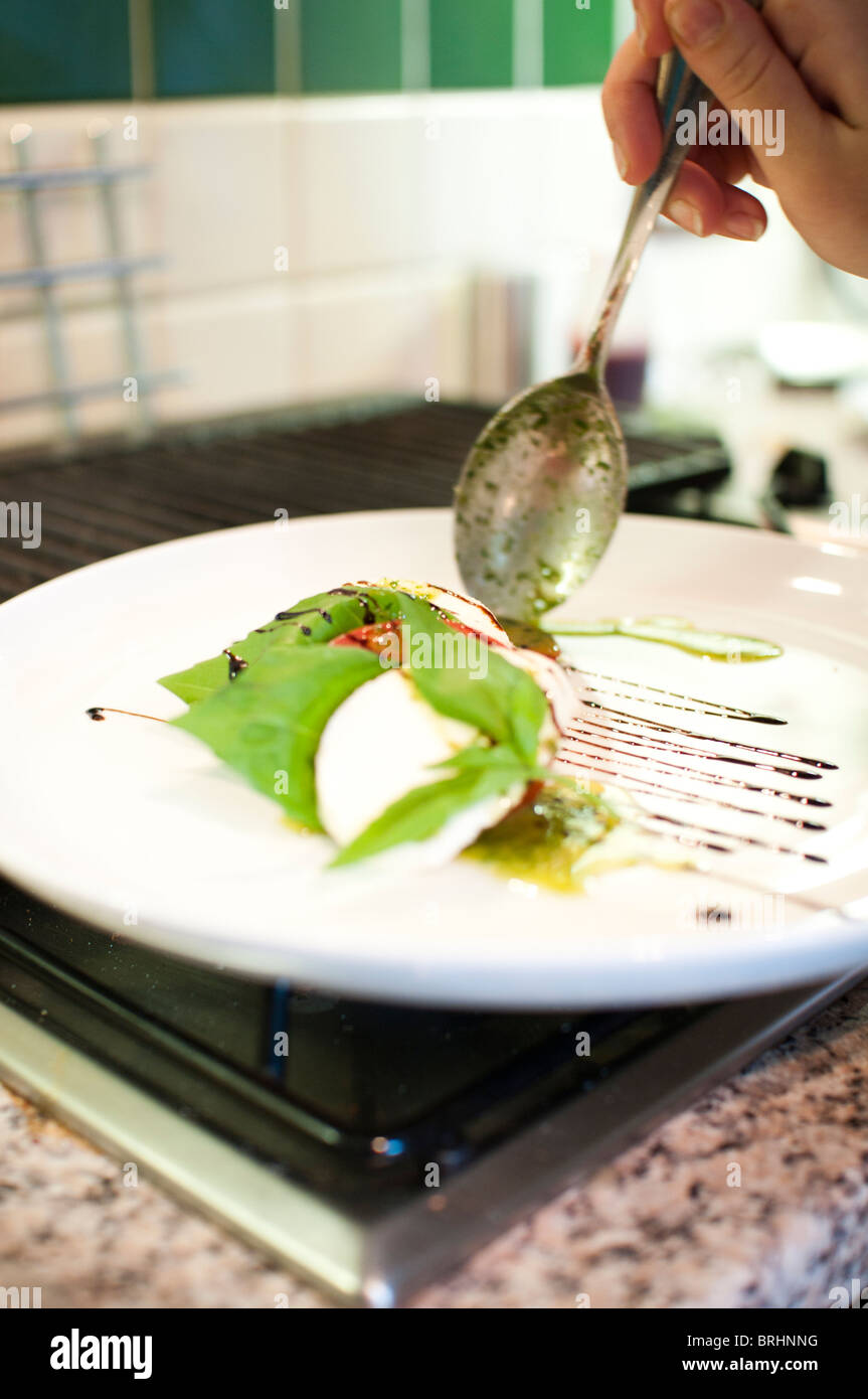 Posh salad with dressing being applied Stock Photo - Alamy