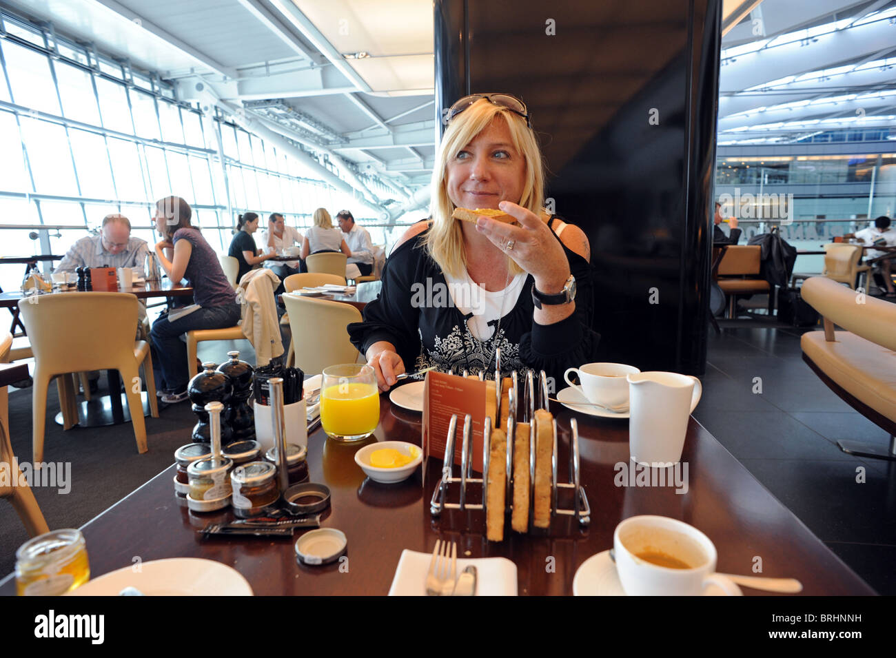 A woman enjoys breakfast in Gordon Ramsay's 'Plane Food' restaurant in ...