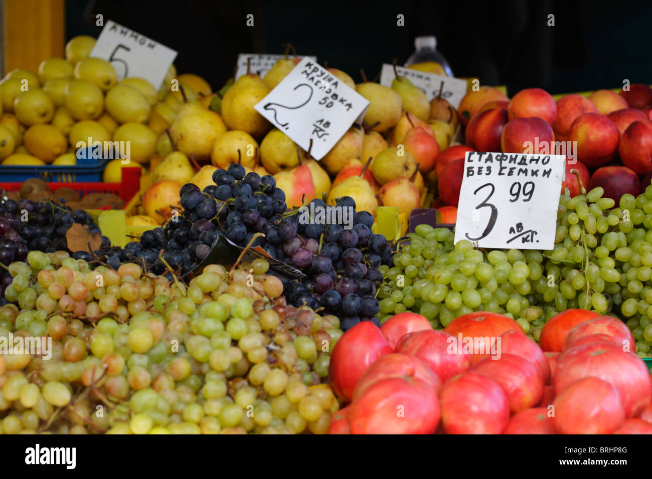 Colorful assorted fruit on a farmer's market with price labels written ...