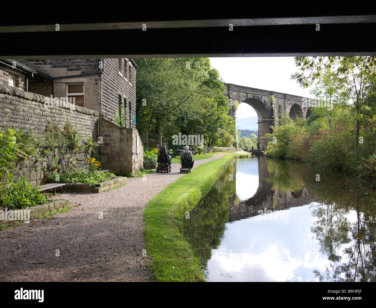 Two men on invalid vehicles on canal towpath, Uppermill, Saddleworth ...