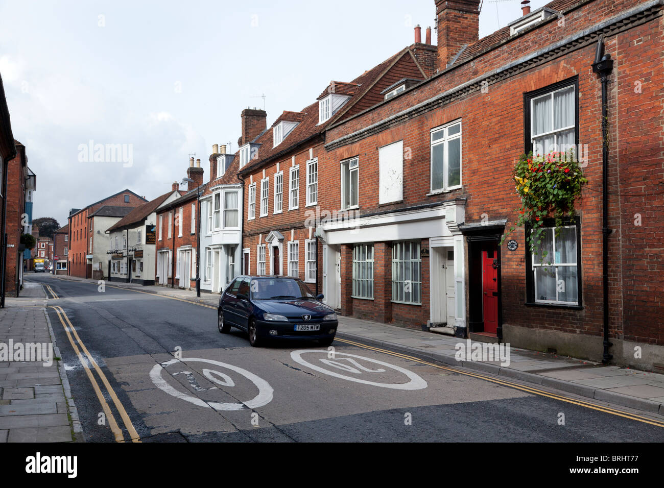 car passing road marking of 20mph in city street Stock Photo - Alamy