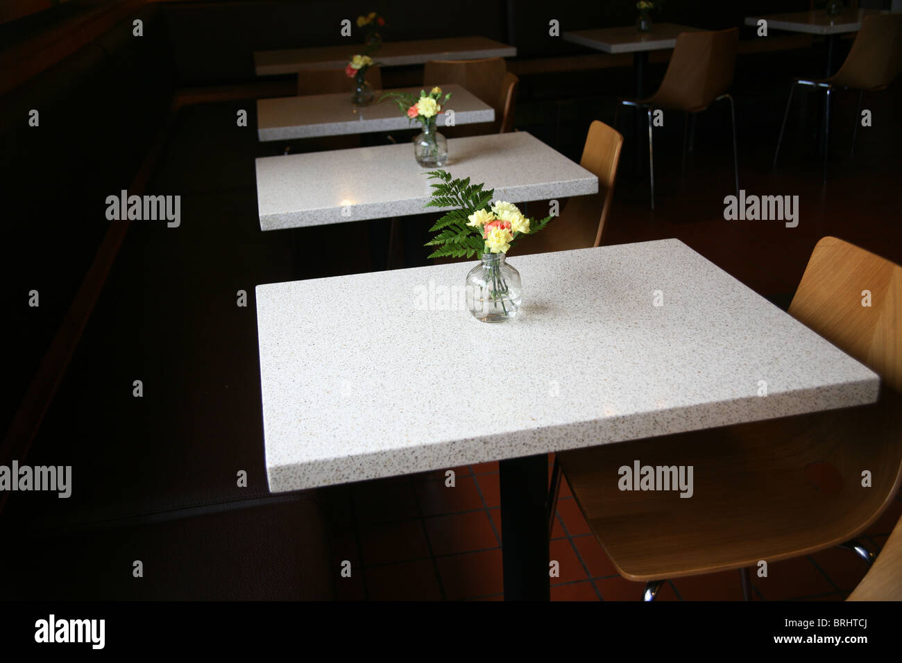 Tables with flowers in restaurant Stock Photo - Alamy