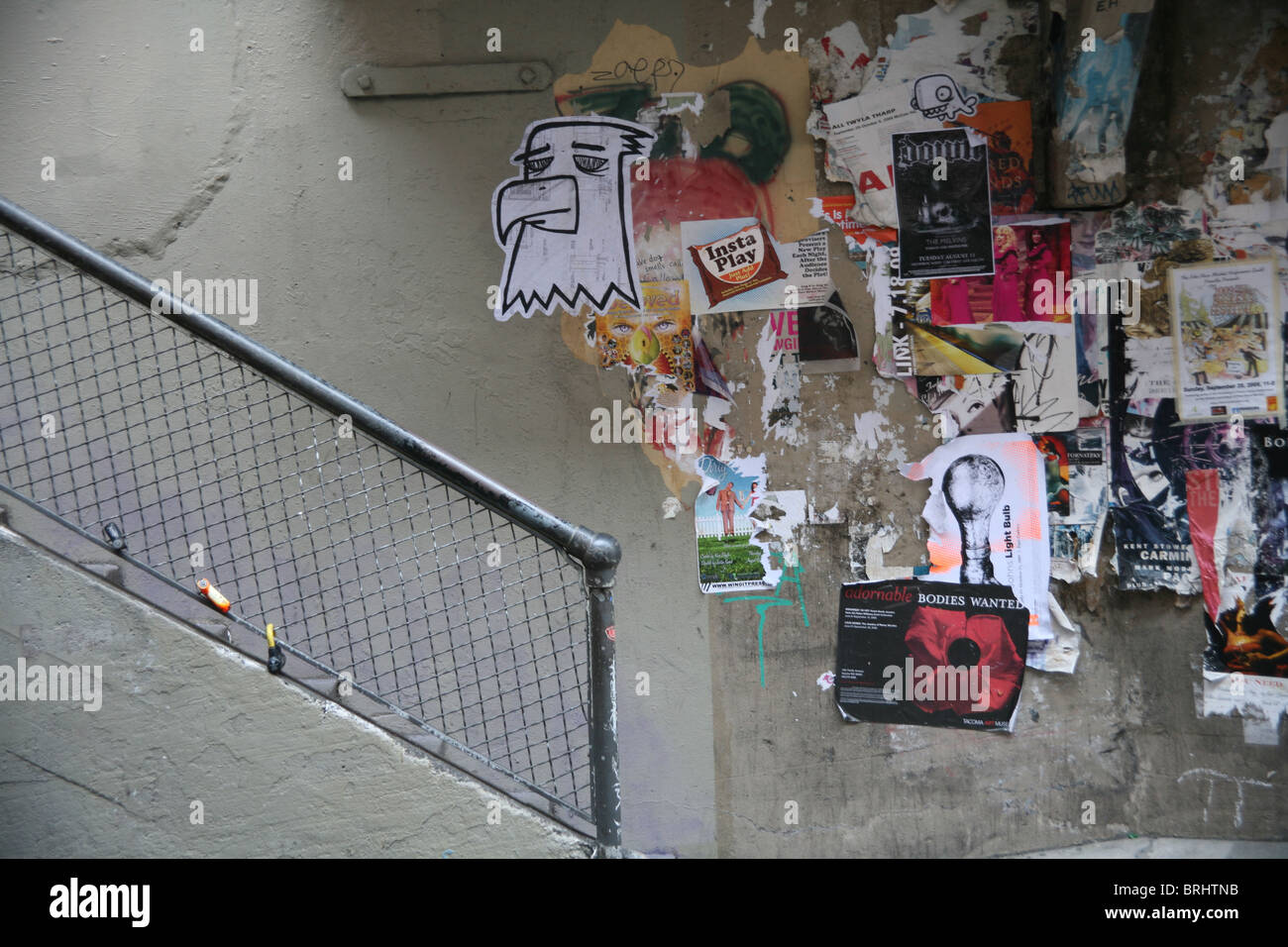 Flyers and posters posted on wall leading down to Post Alley in Seattle ...