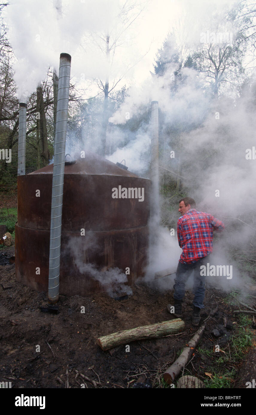 Charcoal making in the Sussex woodland Stock Photo - Alamy