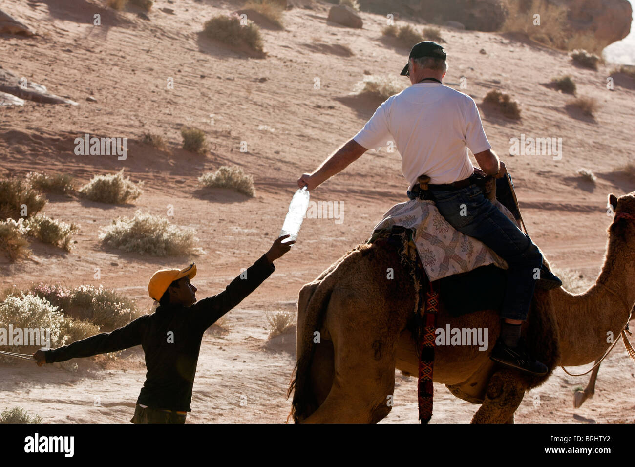 Camel riders in sandy hi-res stock photography and images - Alamy