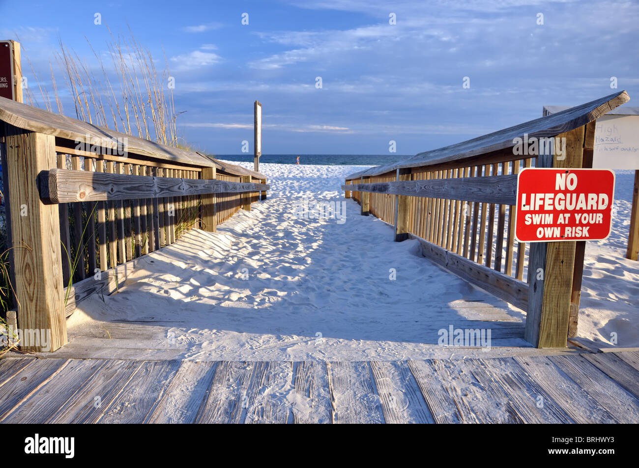 Wooden beach access with lifeguard warning sign Stock Photo - Alamy