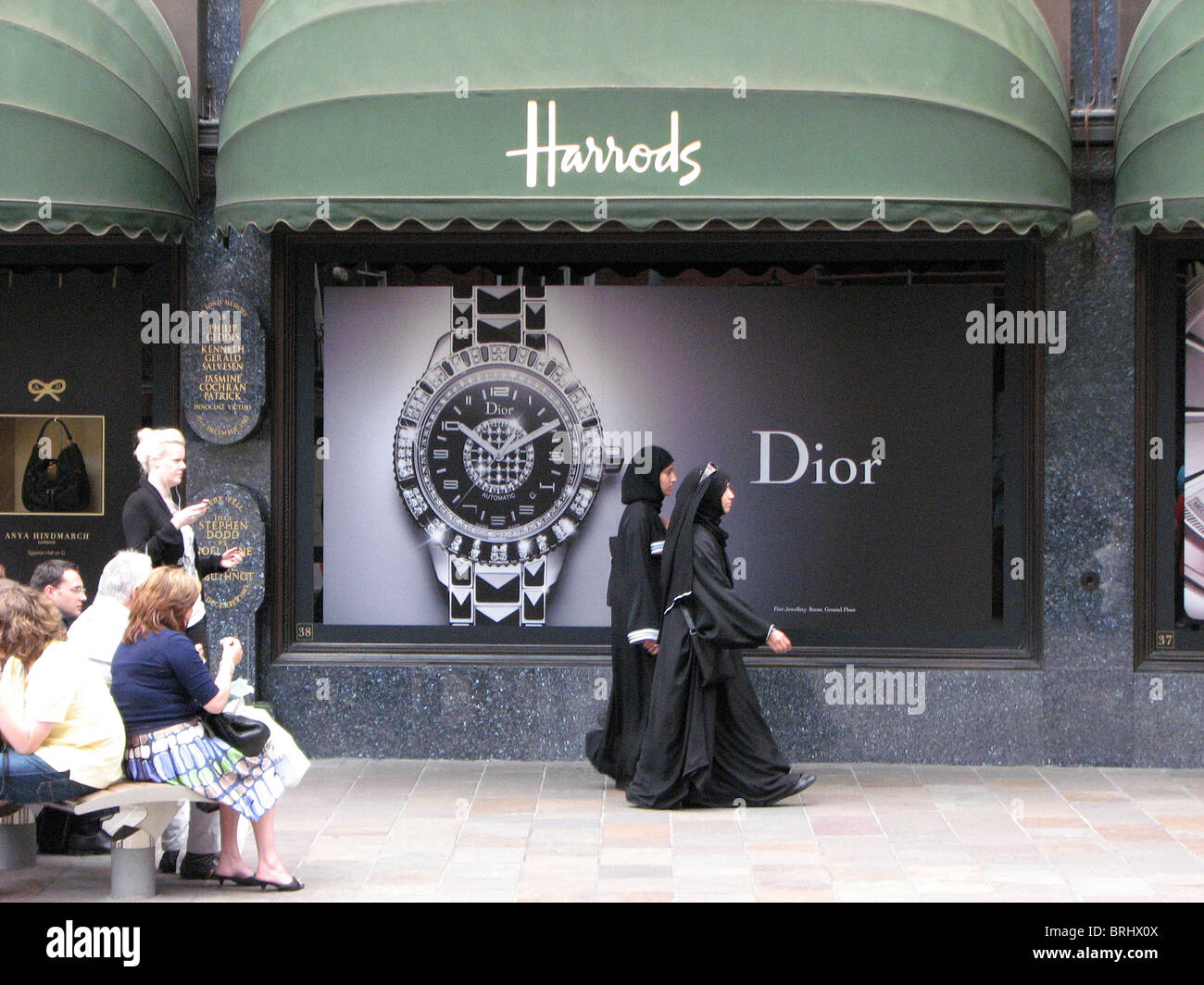 Two Arab women walk passed a Harrods shop window, Knightsbridge, London ...