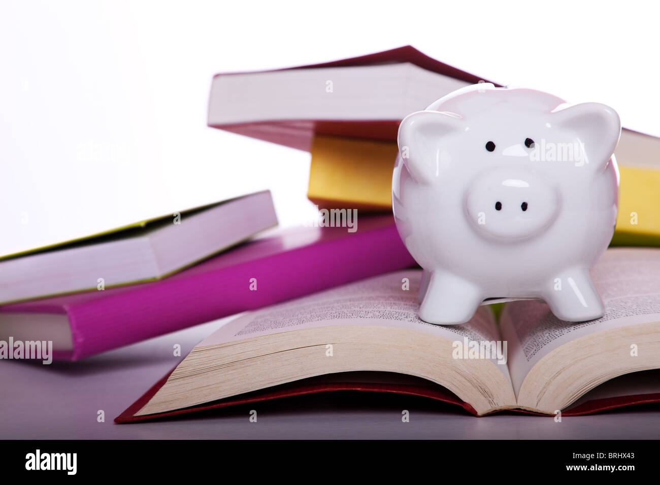 Piggy bank with books Cut Out Stock Images & Pictures - Alamy